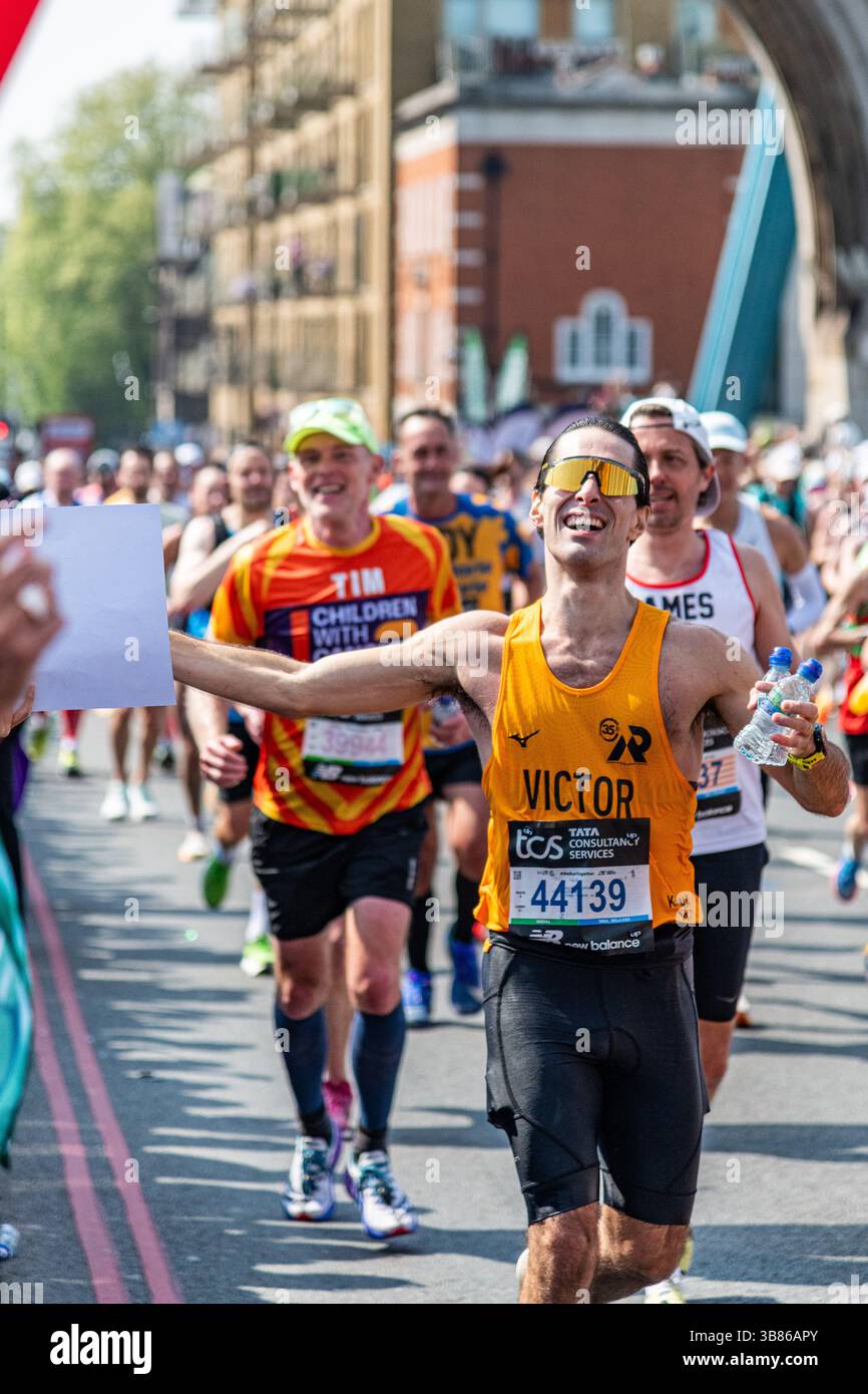 Runners running at the London Marathon 2025 on Tower Bridge in Central ...
