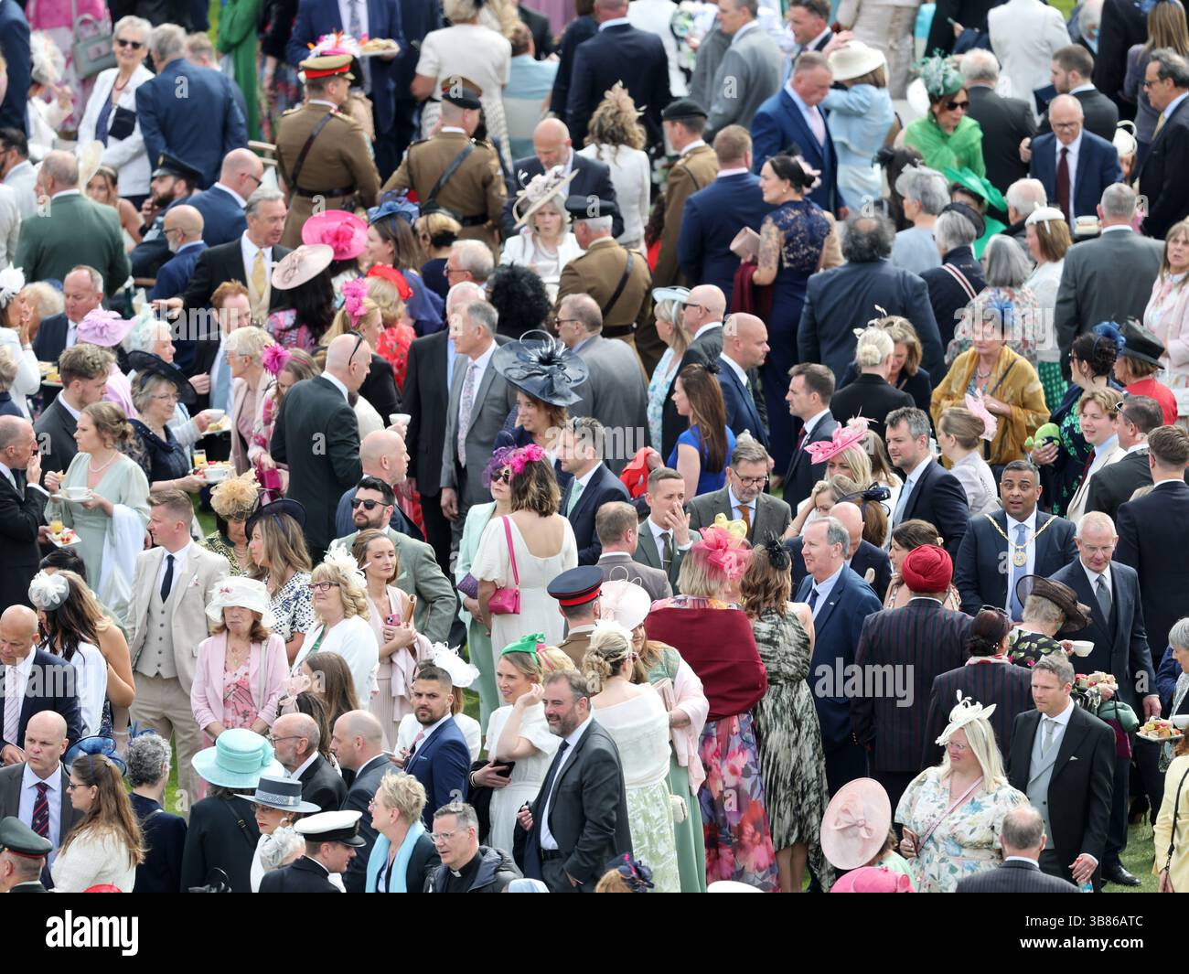 Guests attend a Royal Garden Party at Buckingham Palace, London ...