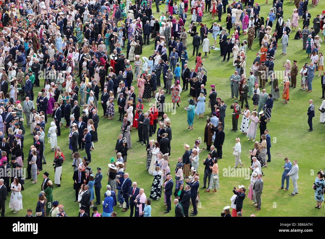 Guests attend a Royal Garden Party at Buckingham Palace, London ...
