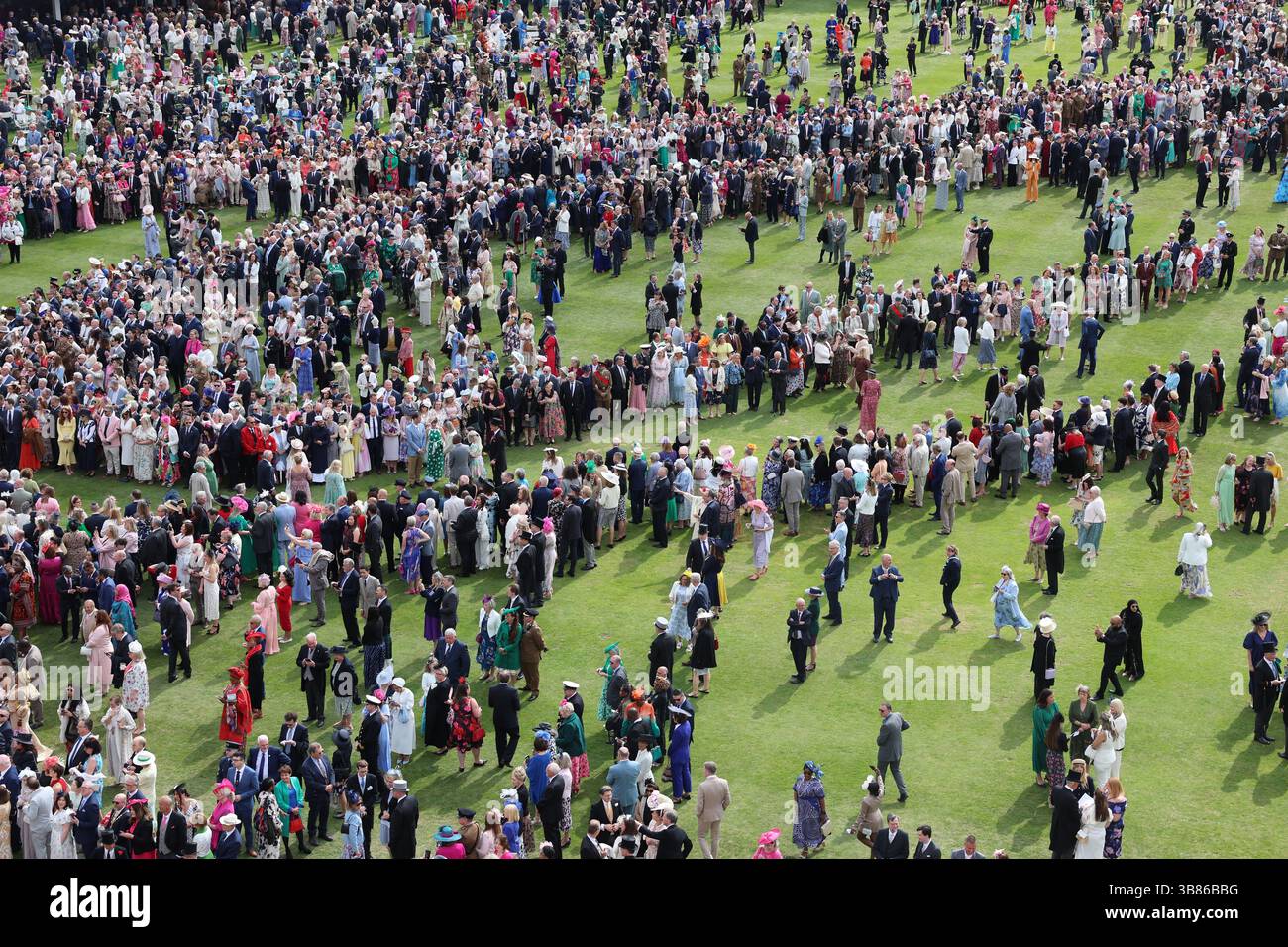 Guests attend a Royal Garden Party at Buckingham Palace, London ...