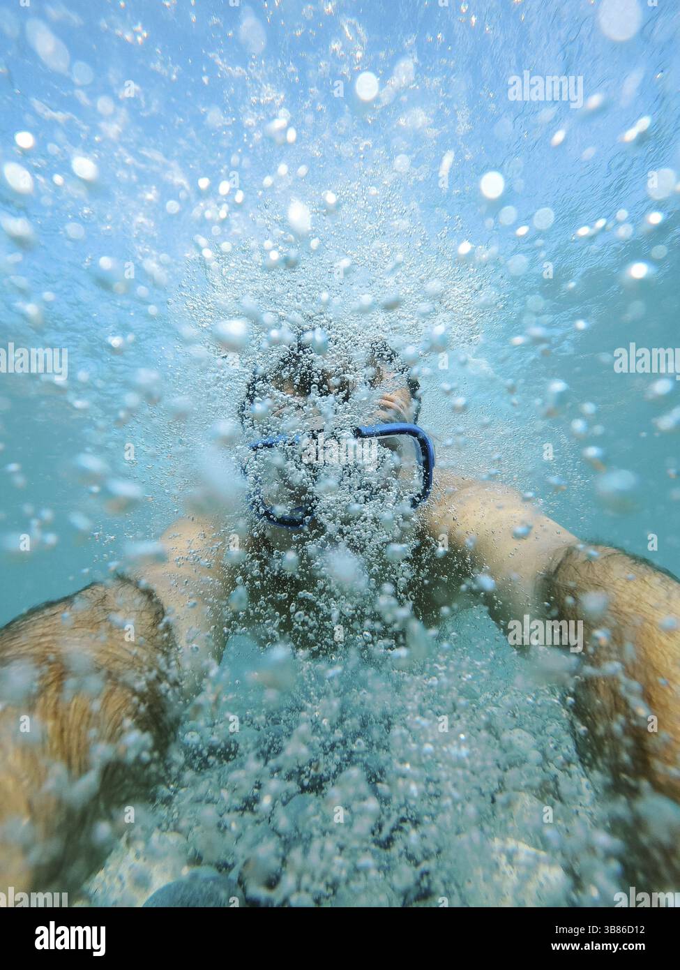 Swimmer in a mask swims in bubbles underwater Stock Photo - Alamy
