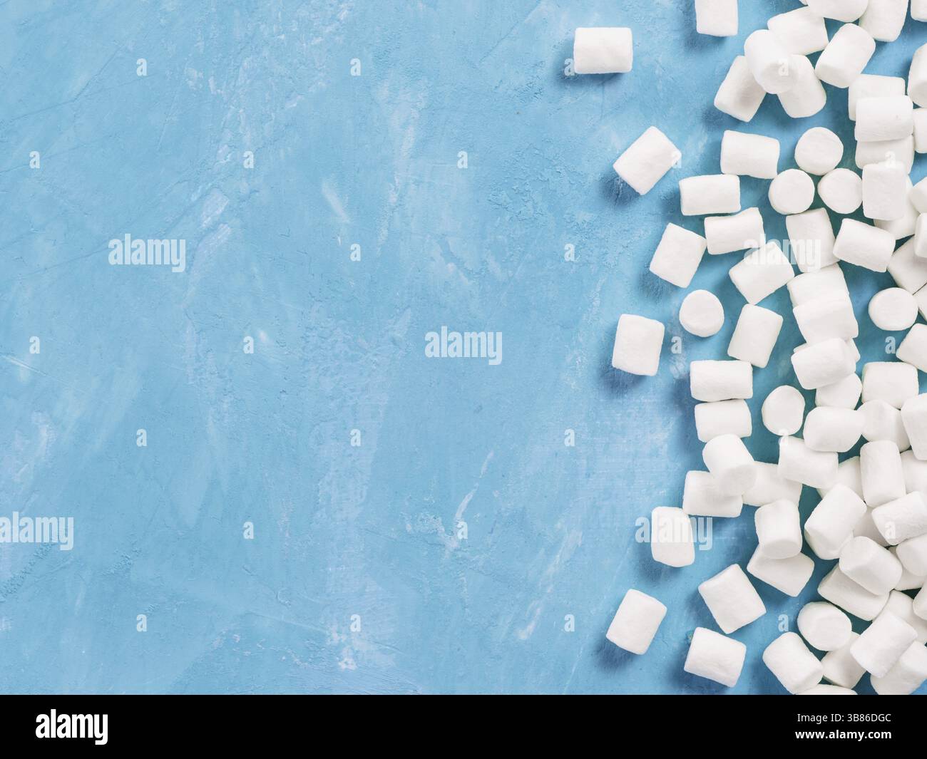 Marshmallows on blue background with copyspace. Flat lay or top view ...