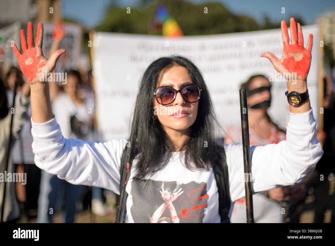 October 29, 2022, Rome, Italy: A woman shows her hands stained with red ...