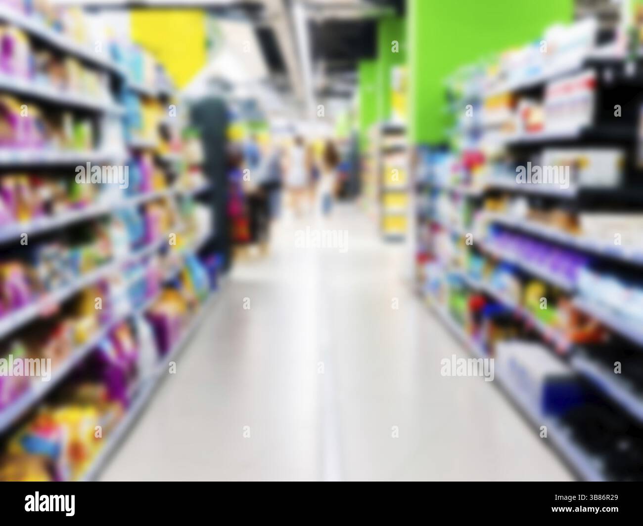 Abstract blurred supermarket aisle with colorful shelves and ...