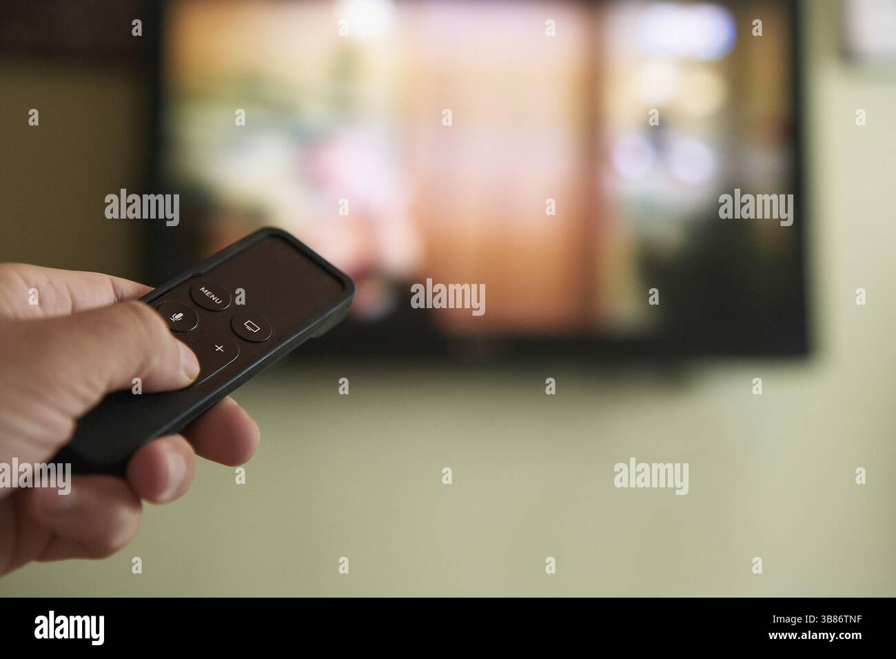 Multimedia streaming concept. Hand holding remote control. TV screen ...