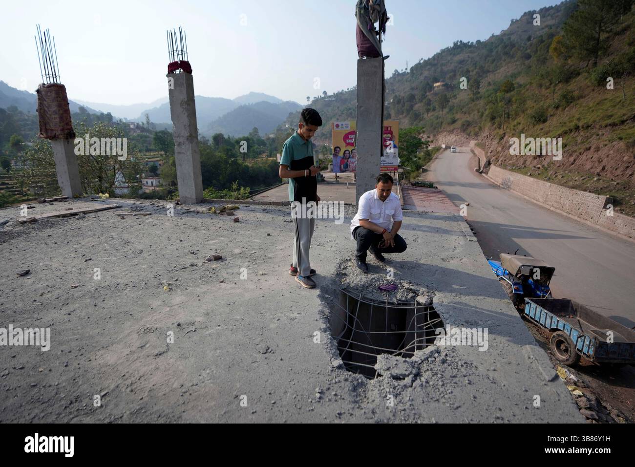 A man inspects the roof of a building that was damaged by Pakistani ...