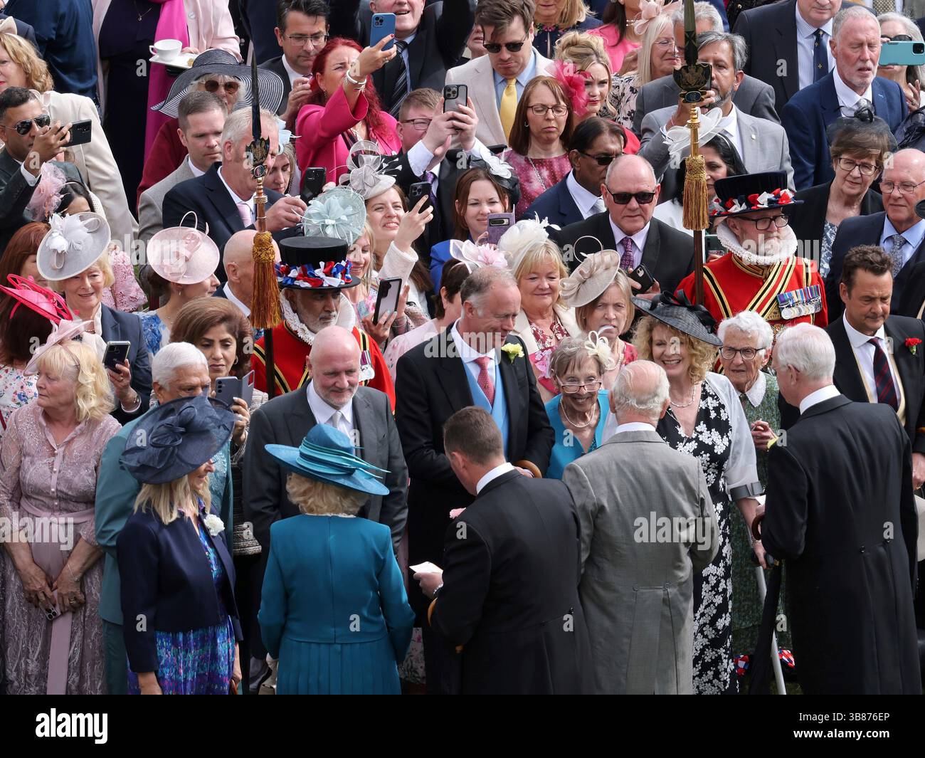 Britain's King Charles III and Queen Camilla meet with guests during a ...