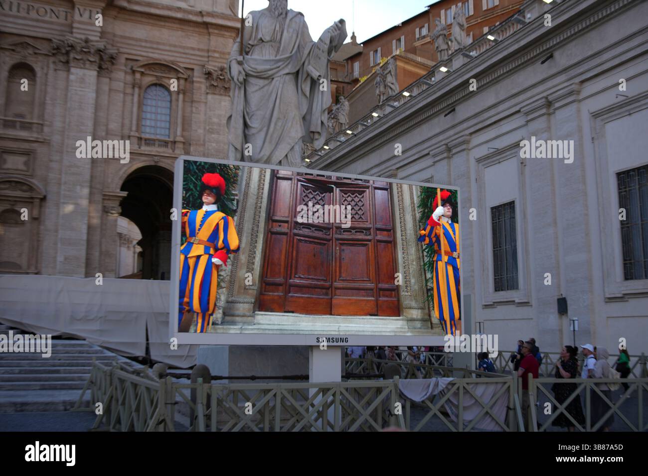 A giant screen shows Swiss Guards standing as the door of the Sistine ...