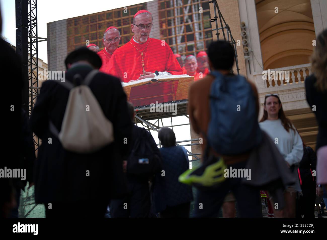 People watch a giant screen showing Cardinal Pierbattista Pizzaballa ...