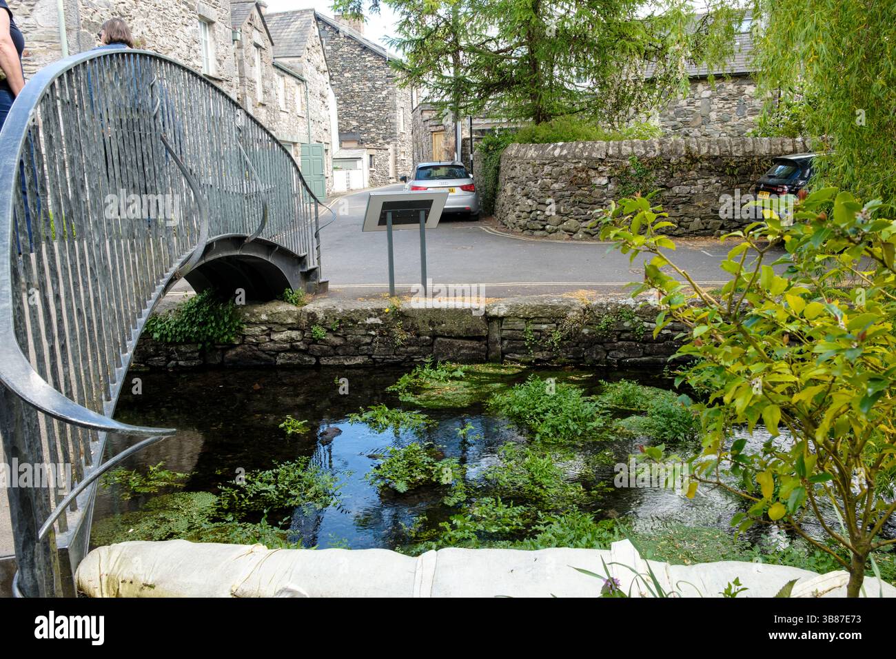 Metal footbridge over the River Eea in Cartmel, Cumbria, UK Stock Photo ...