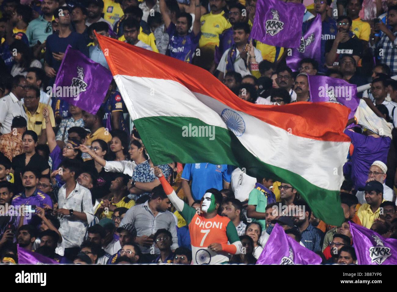 A cricket lover national flag color paints his body and waves the ...