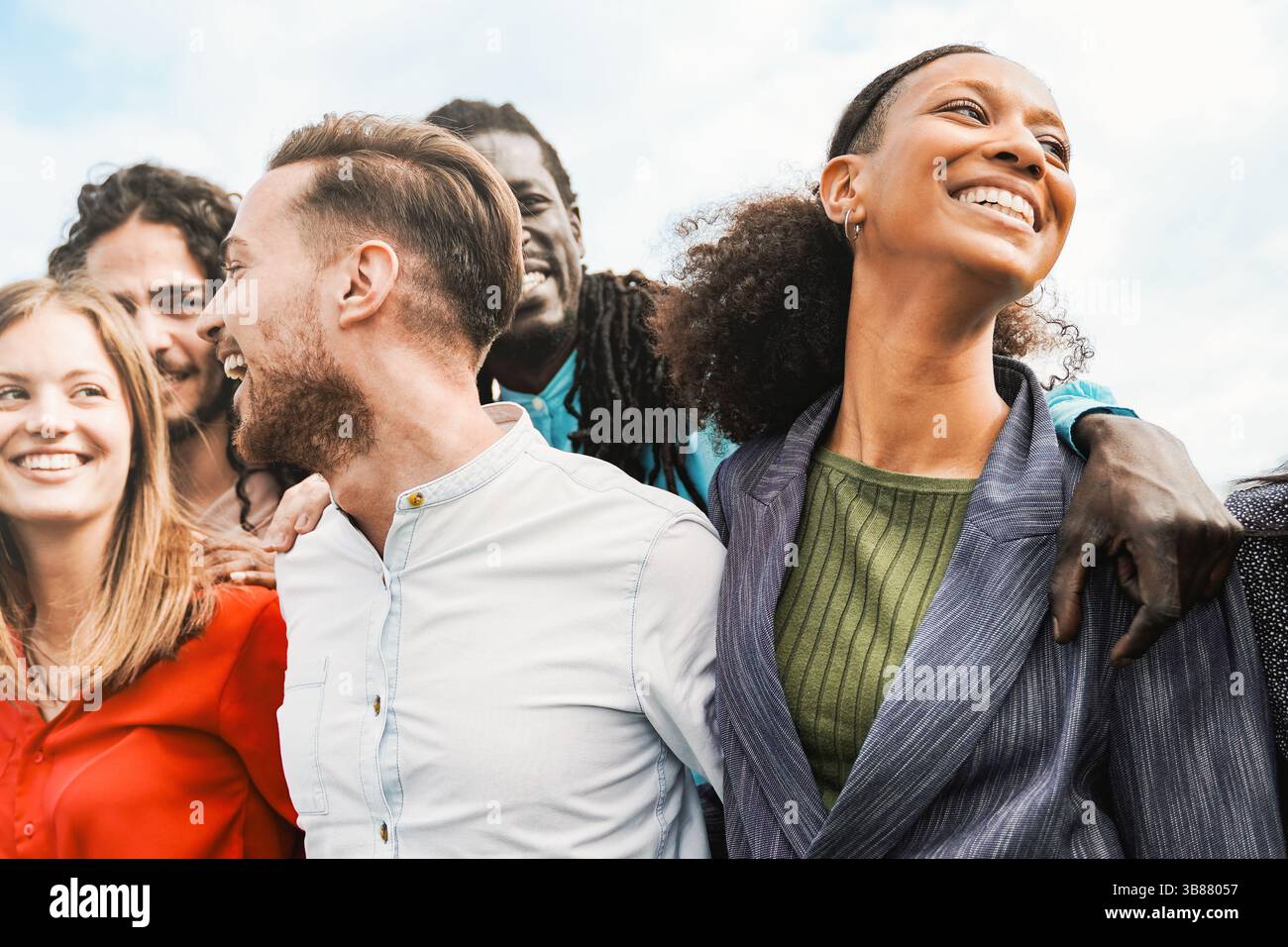 Diverse group of friends have fun outdoors. Young people hang out together. Youth culture and ...