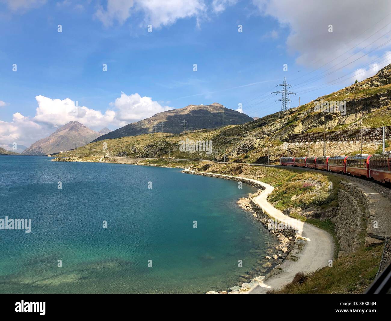 The Bernina Express alongside Lago Bianco in Switzerland Stock Photo ...