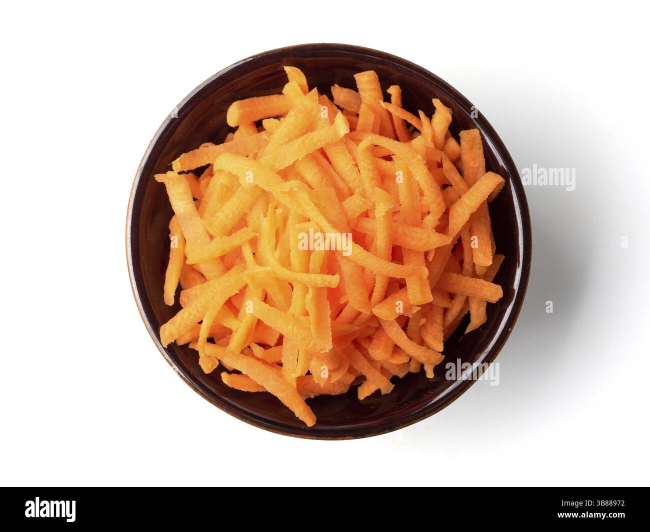 Fresh organic shredded carrots in small white bowl. Raw grated carrots ...