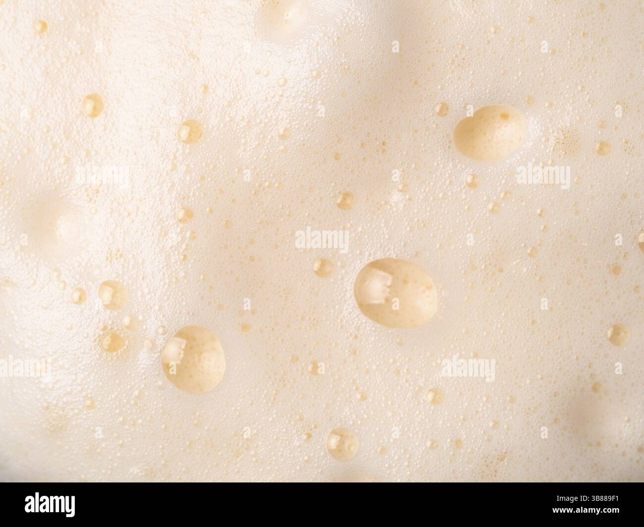 Foam texture extreme close up as background. Milkshake or cappucino ...
