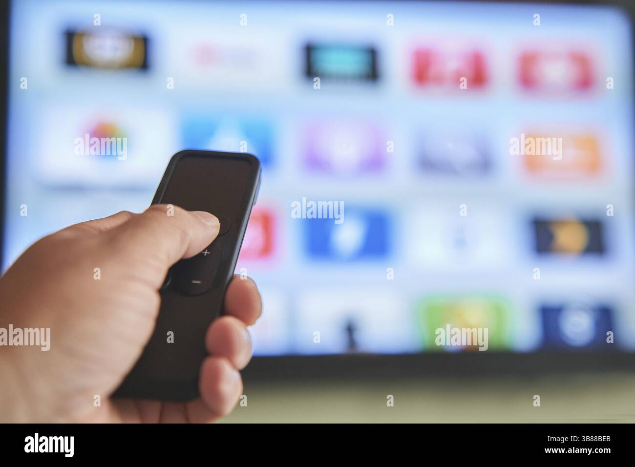 Multimedia streaming concept. Hand holding remote control. TV screen ...