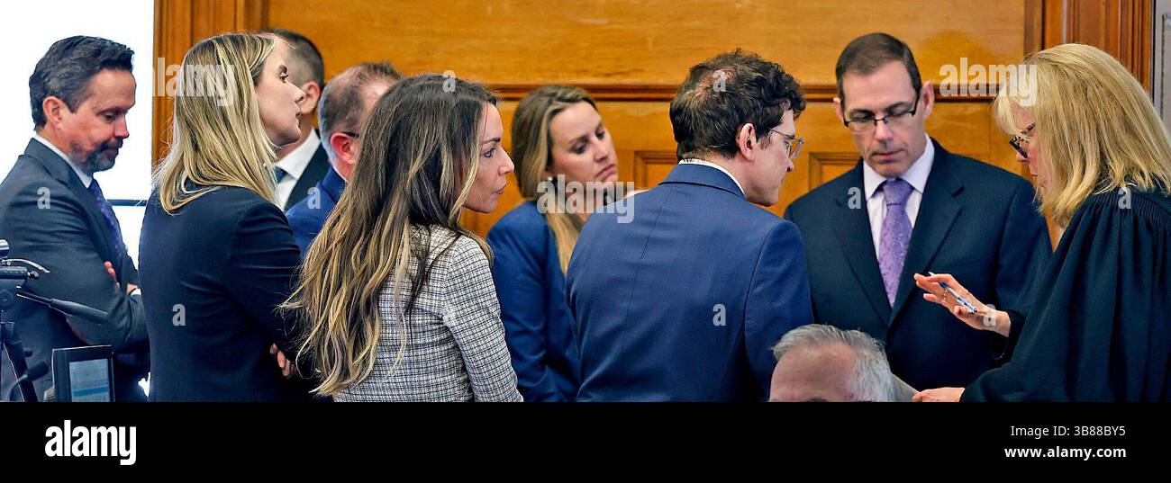 Karen Read, center, listens to lawyers Robert Alessi and Hank Brennan ...