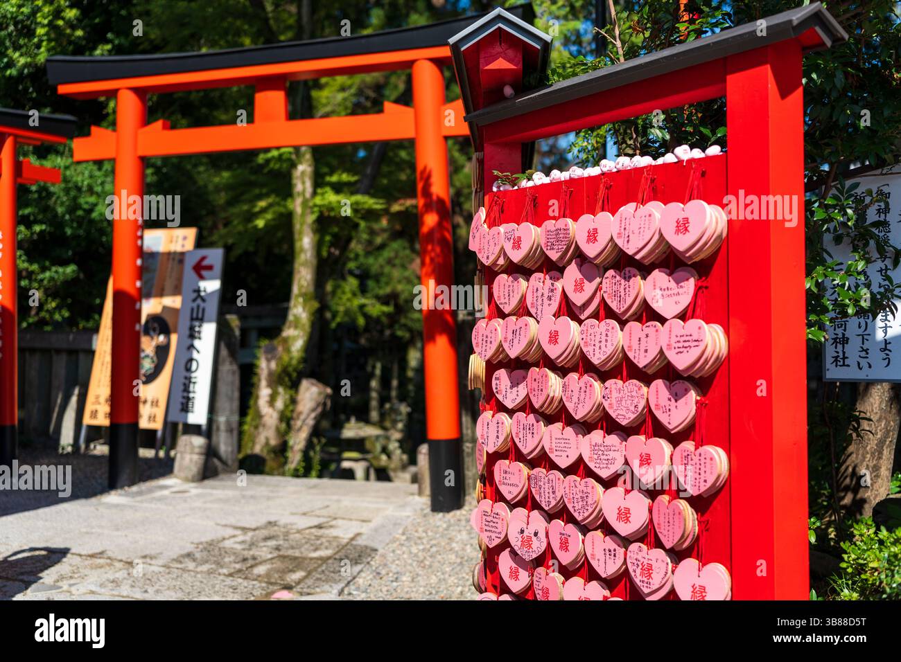 Rows of red torii gates and heart-shaped ema wooden plaques at Sanko ...