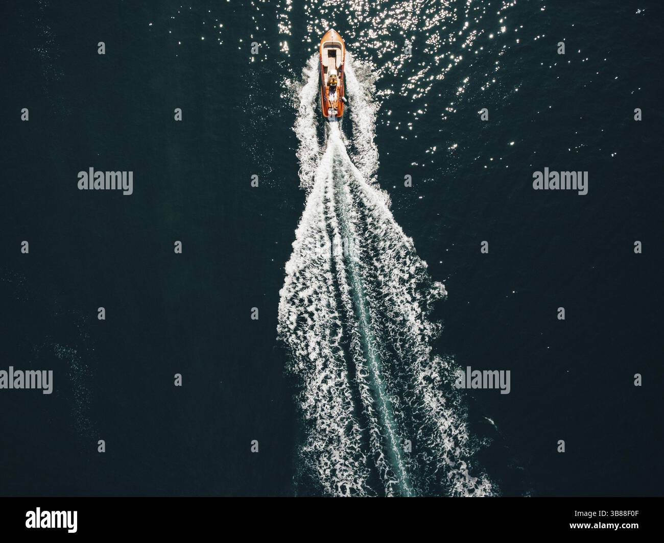 The motor boat is cutting through the sea water. Drone photo, top view ...