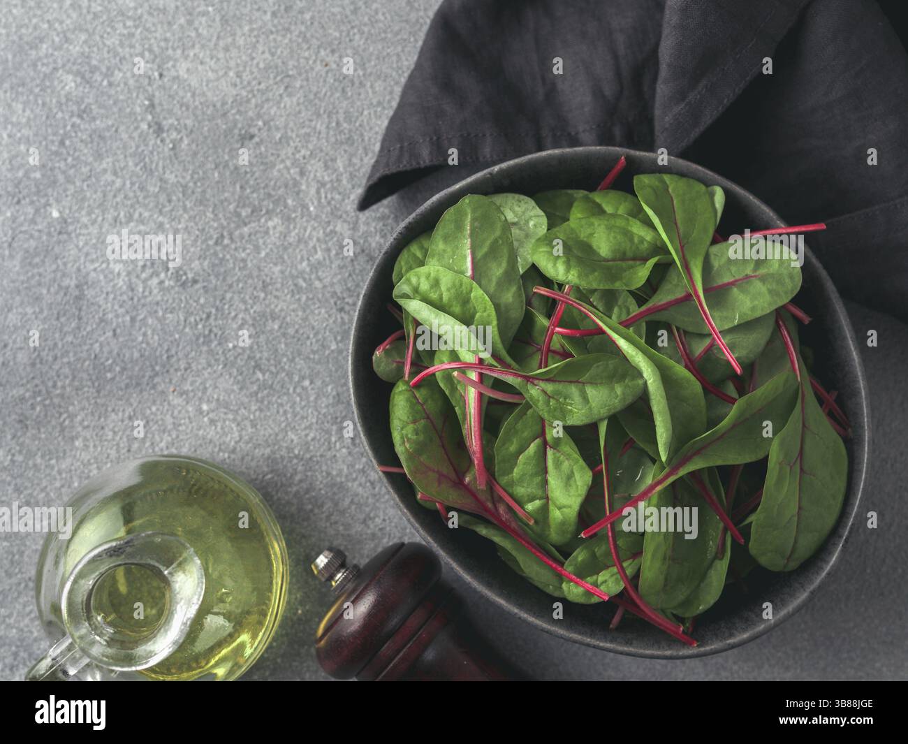 Fresh salad of green chard leaves or mangold on gray stone background ...