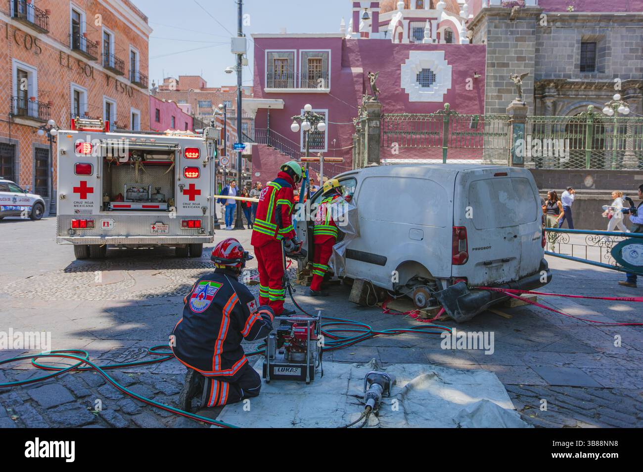 A fire truck and rescue team simulate the extraction of victims from a ...