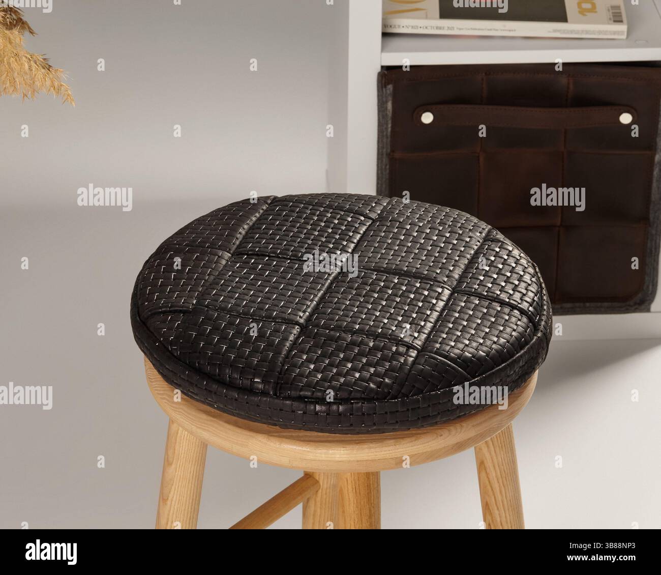 Round black leather padded stool in modern interior design setting ...