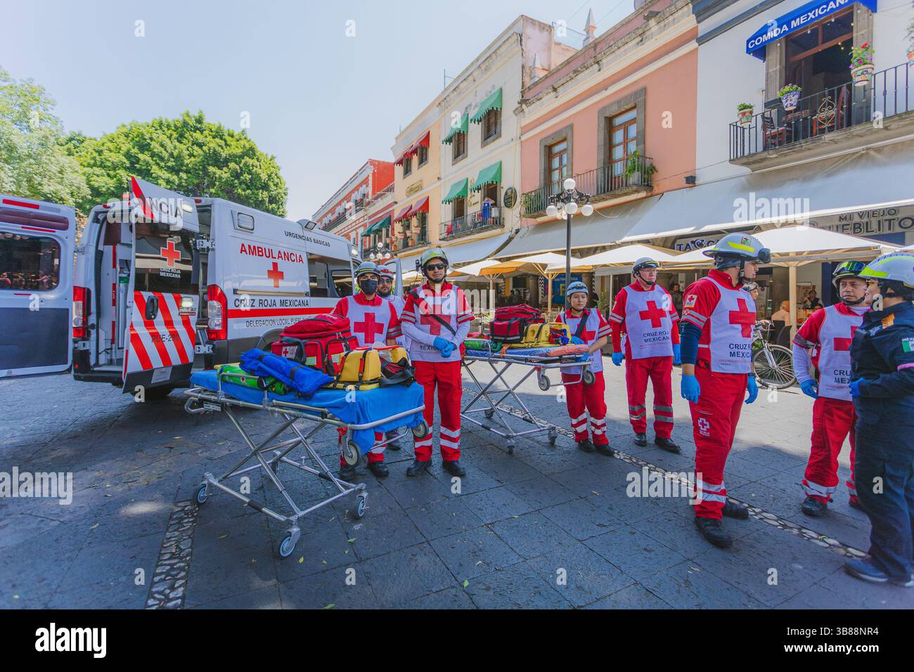 A group of Red Cross paramedics stand ready to assist injured ...