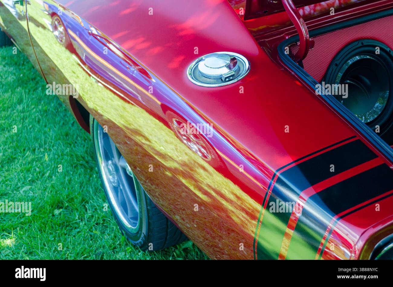 Red 1970's era Muscle Car left rear quarter view, reflecting another ...