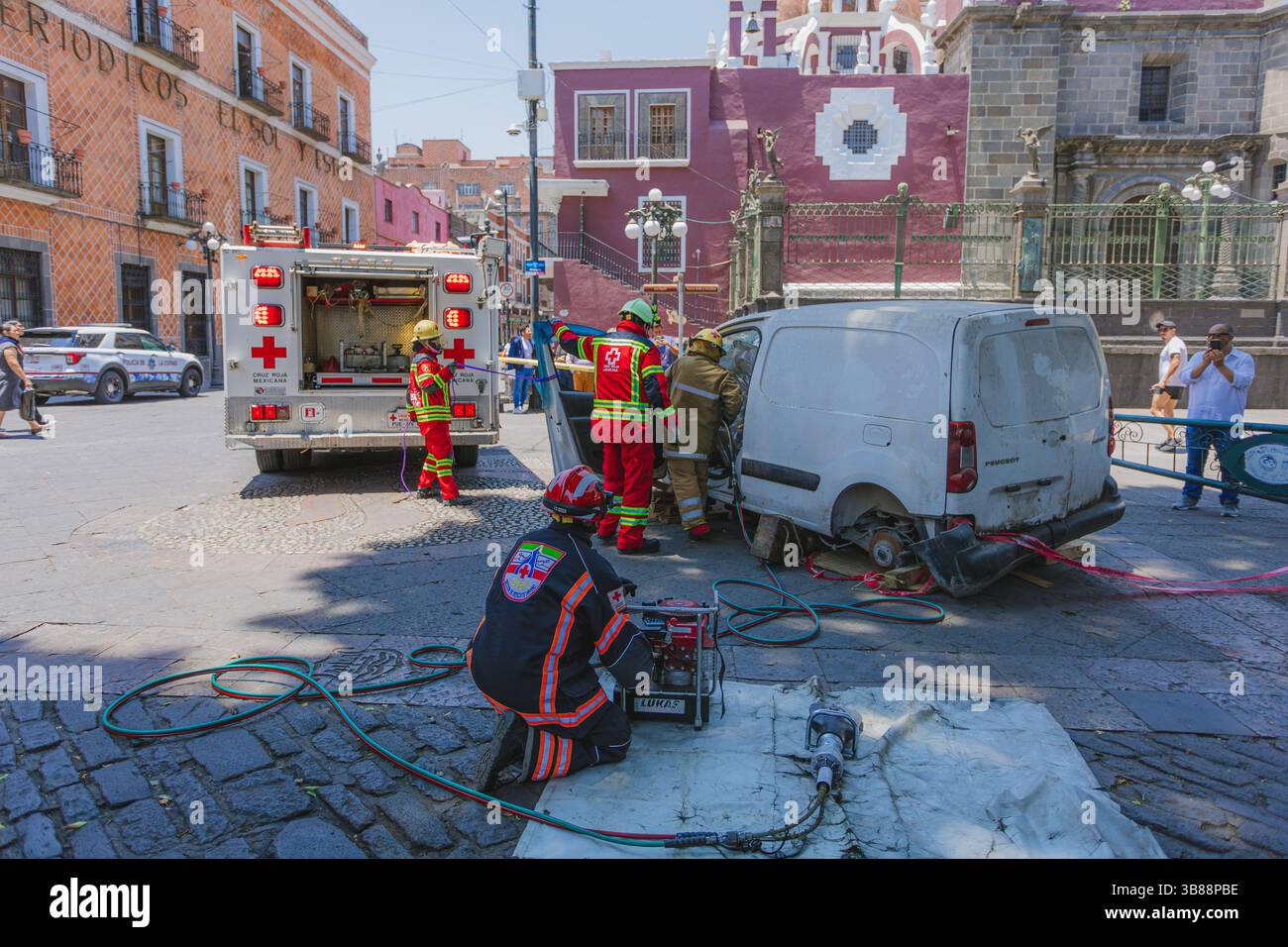 A fire truck and rescue team simulate the extraction of victims from a ...