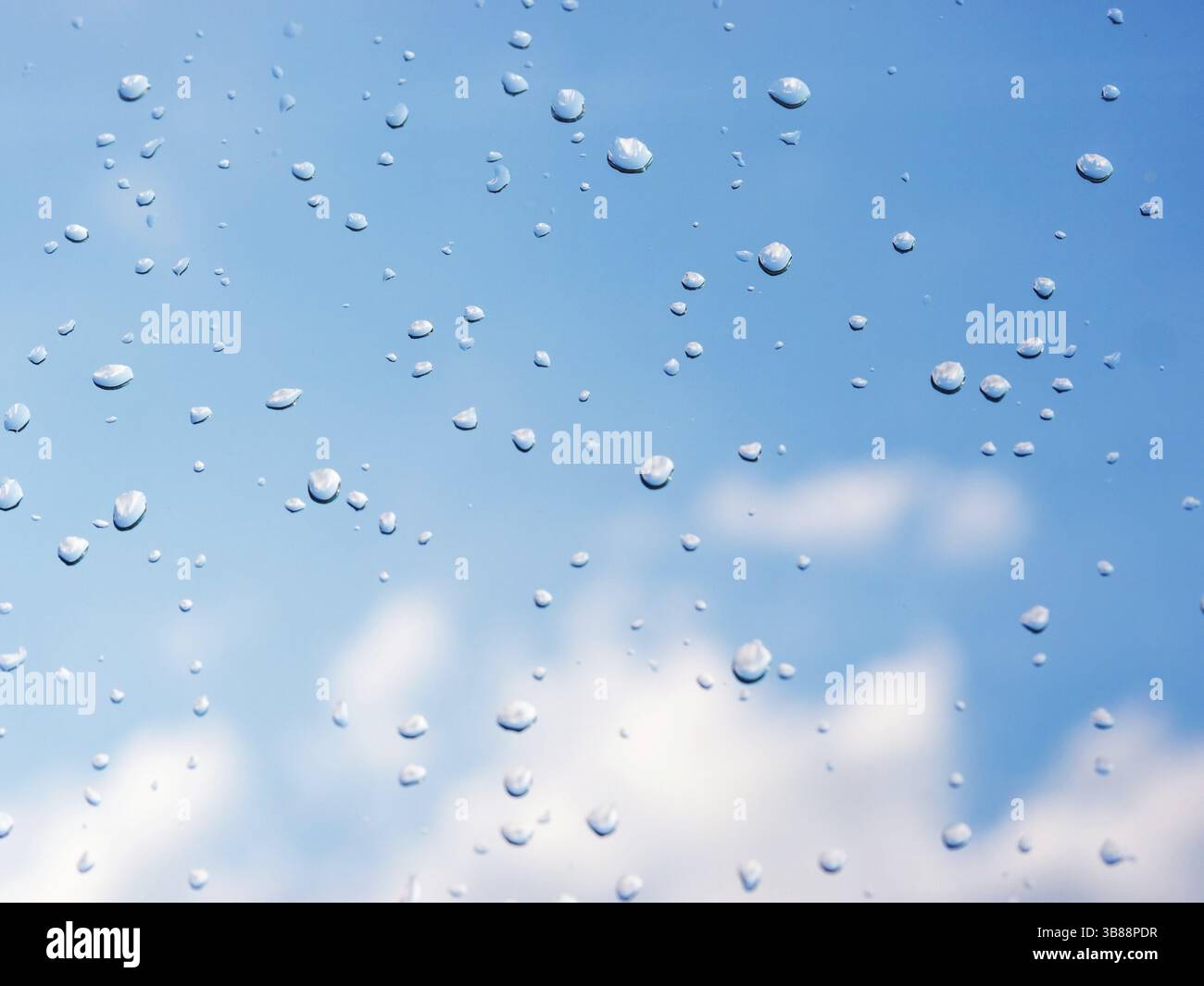 Water drops of rain on blue glass background. Rain drops on window ...