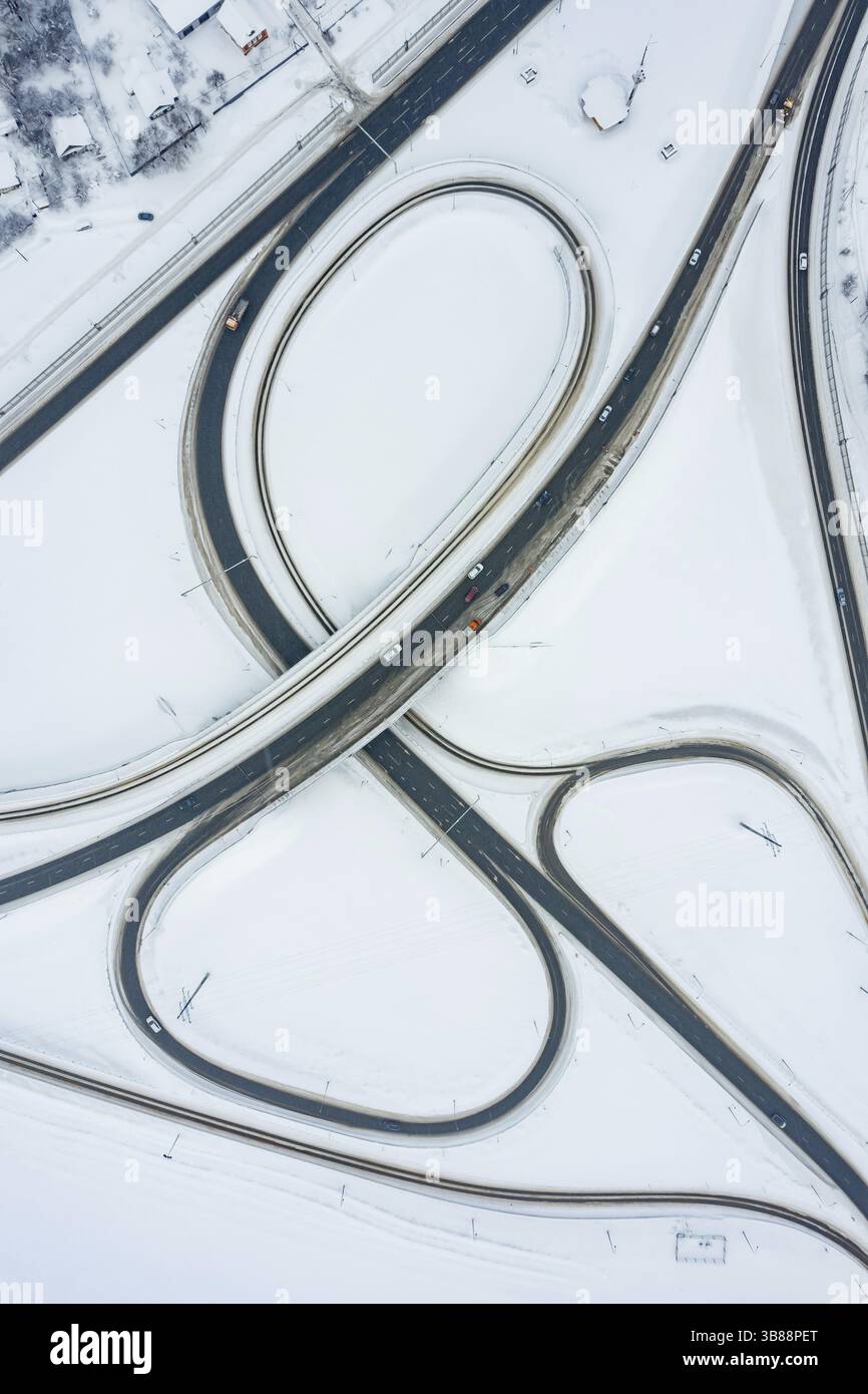 Aerial top view of road junction in winter. Intersection looks like ...