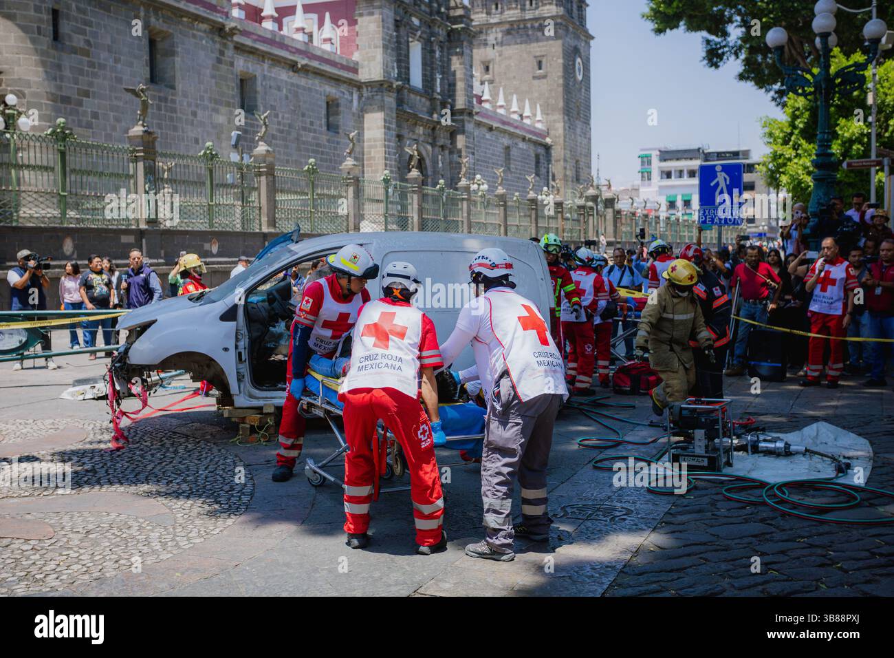 A fire truck and rescue team simulate the extraction of victims from a ...