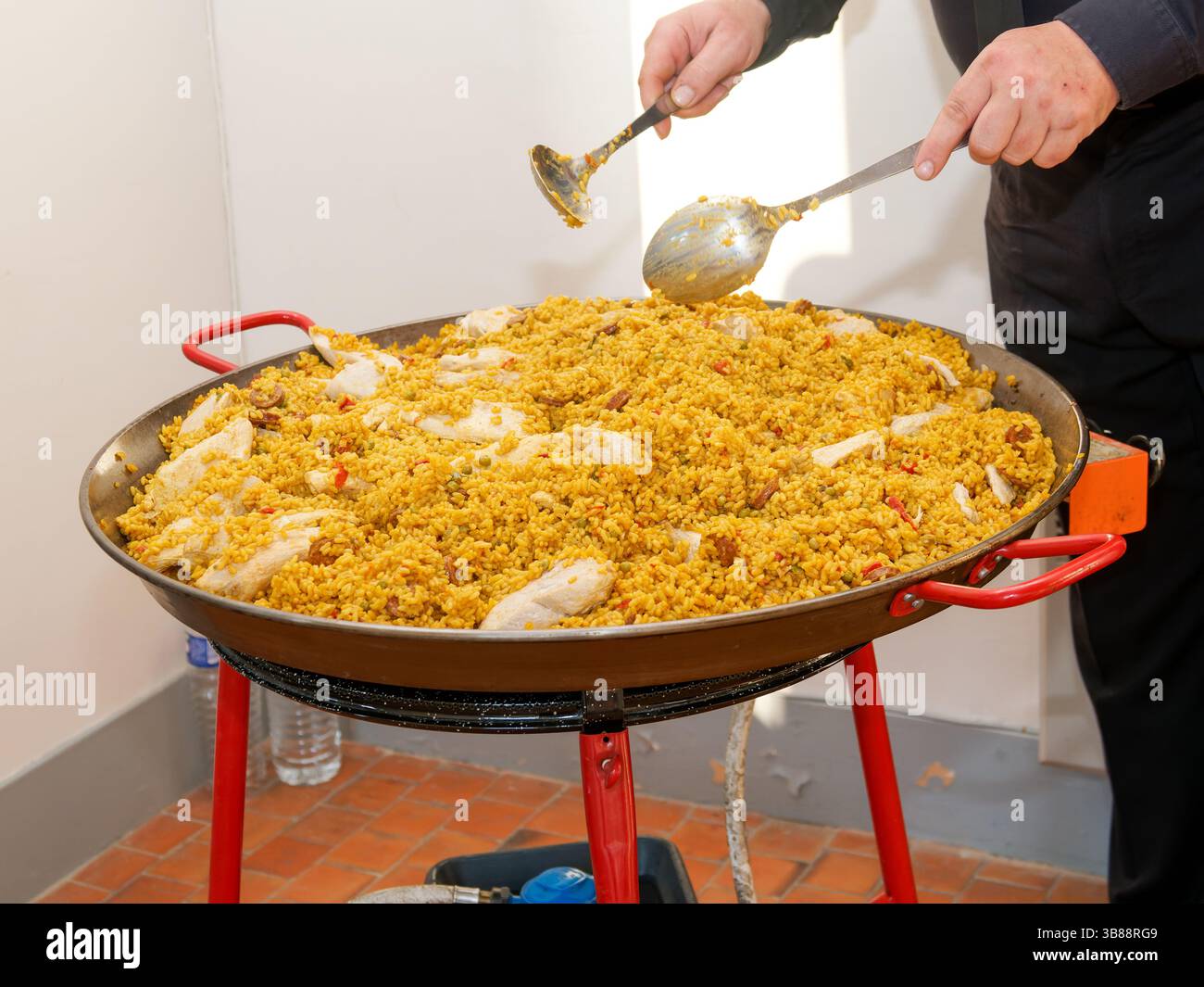 Large paella cooking in a traditional pan for an outdoor event or ...