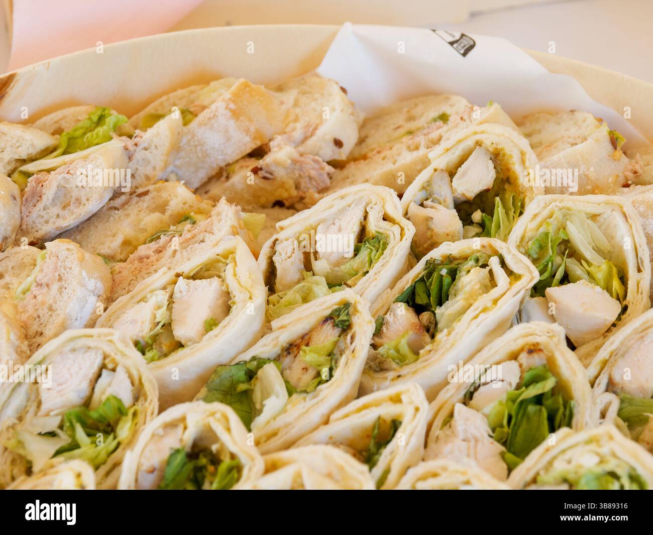 Mini ham and salad wraps served as cold appetizers at a wedding buffet ...