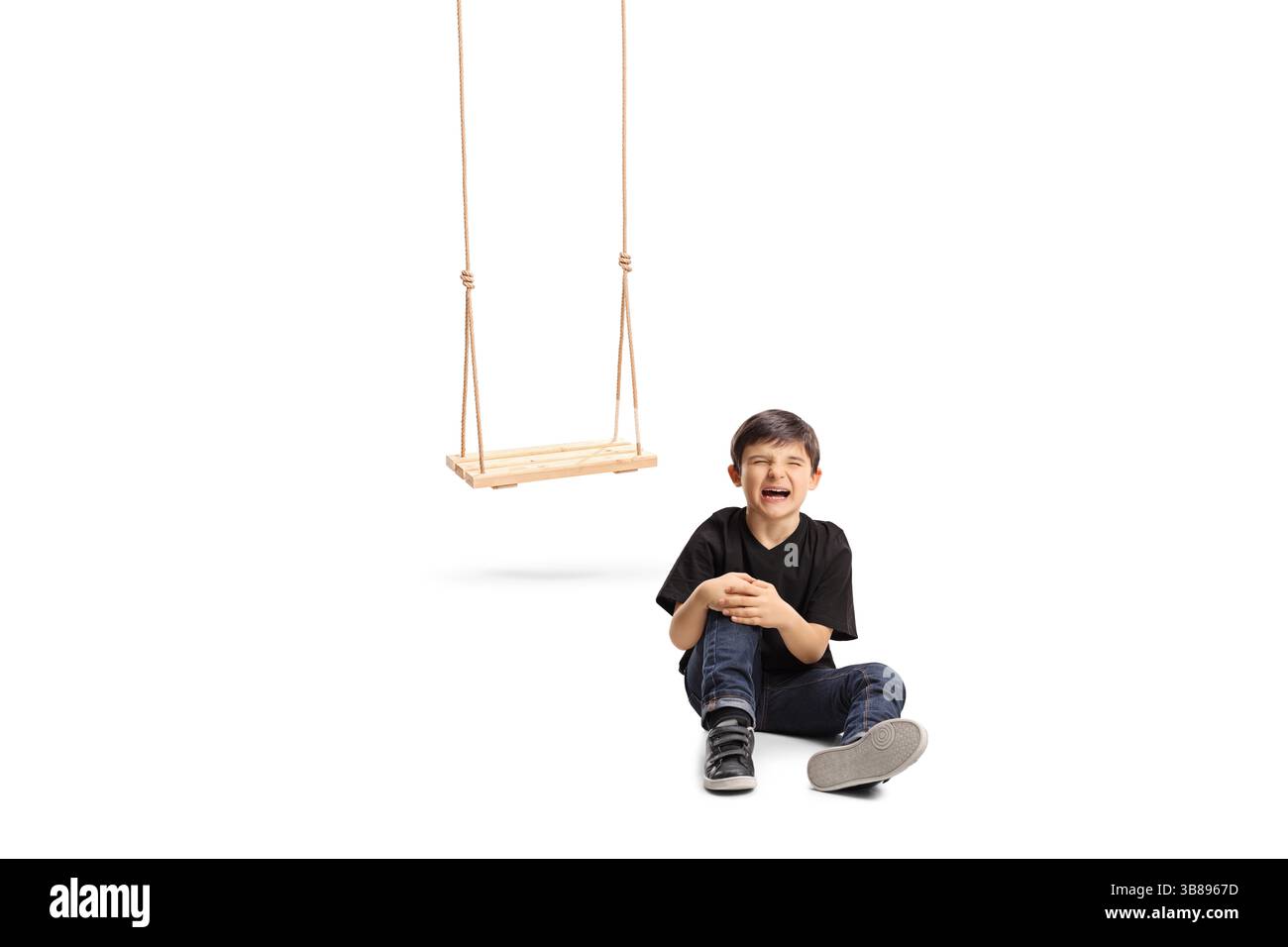Boy falling from a swing and hurting knee isolated on white background ...