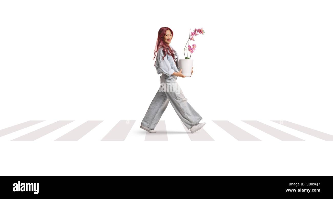 Full length profile shot of a young asian woman carrying an orchid ...