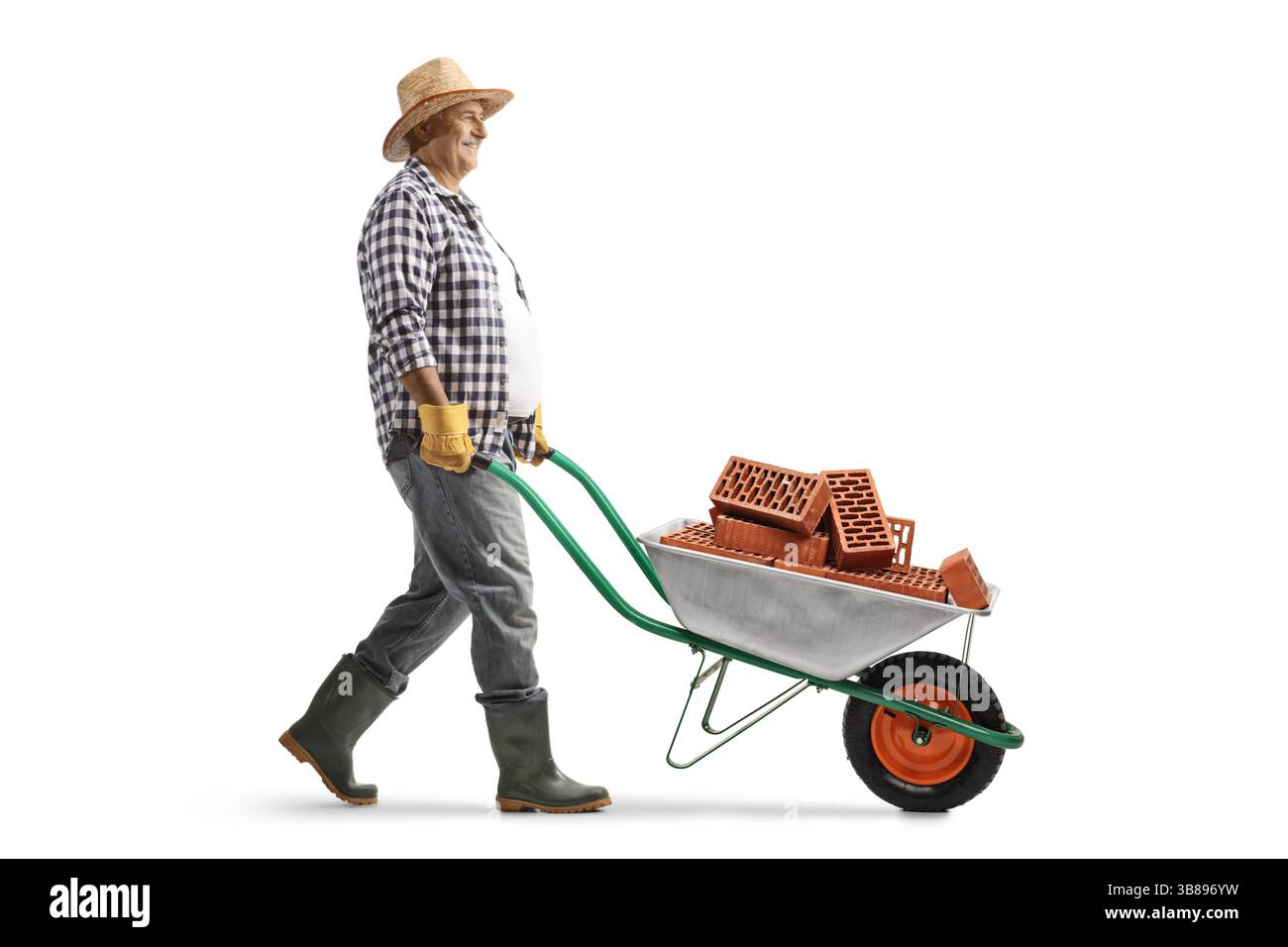 Man walking and pushing bricks in a wheelbarrow isolated on white ...