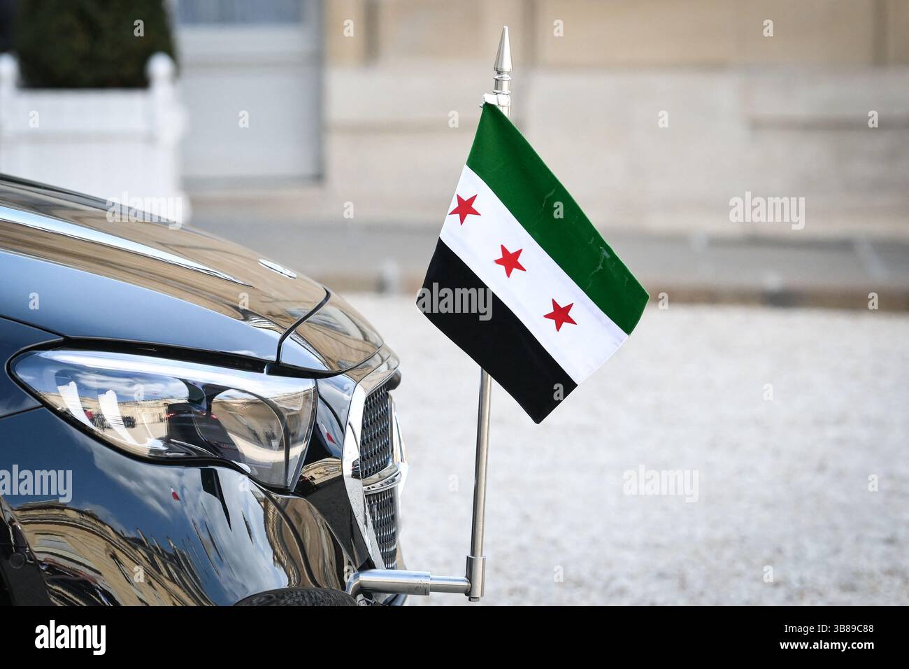 This photograph shows the Syrian national flag on the official car of ...