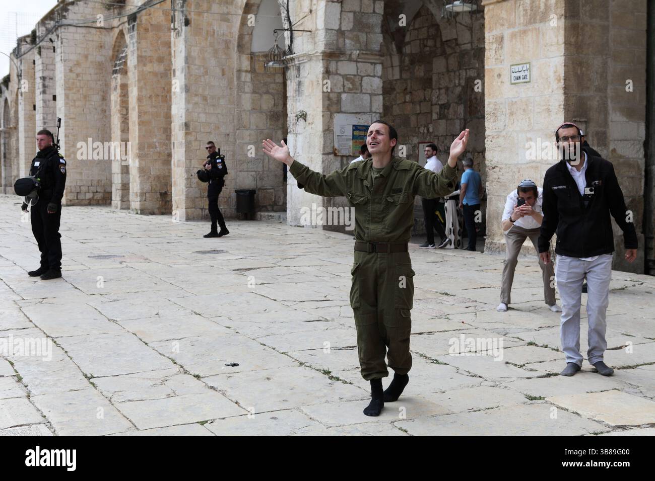 Temple Mt., Young Jew in army uniform prays with devotion his hands up ...