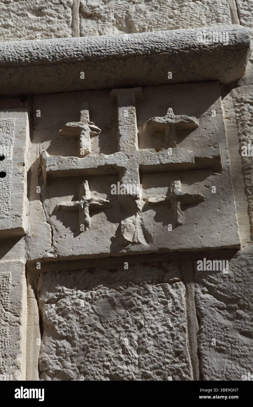 Jerusalem Cross engraved on the wall at the entry to the Catholic ...