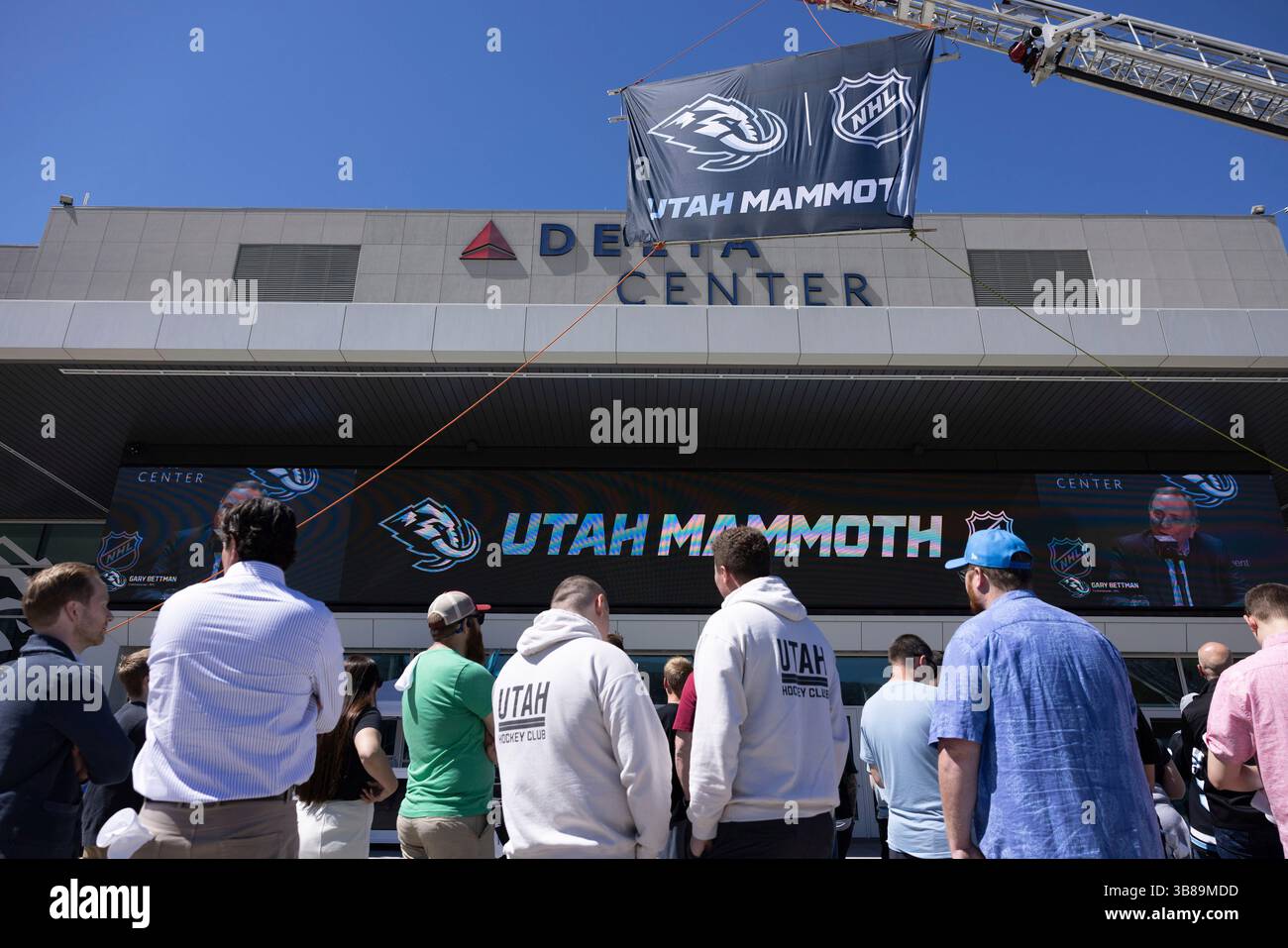Fans watch outside Delta Center watch the live press conference ...