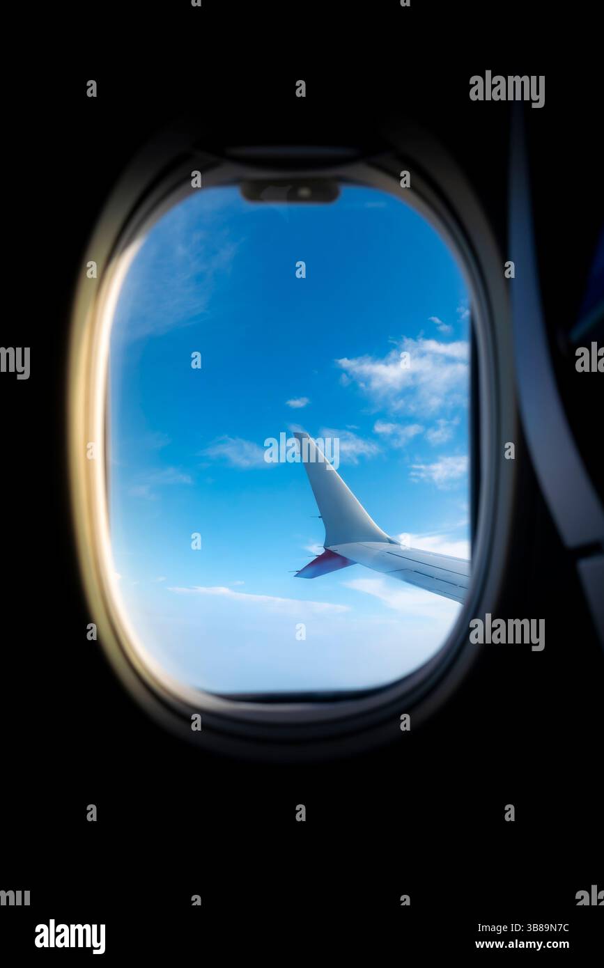 View from inside an airplane showing the aircraft wing against a bright ...