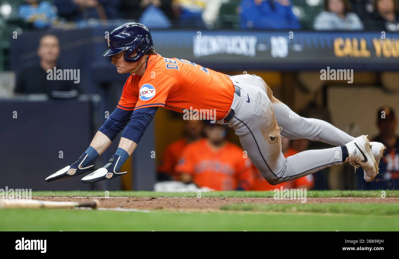 Houston Astros' Zach Dezenzo slides safety into home plate against the ...