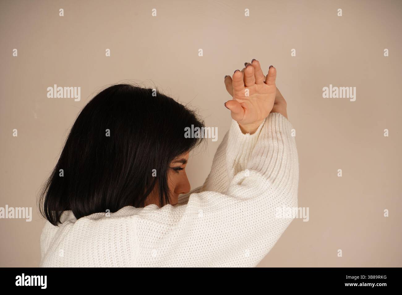 The gesture shows determination and resolve. A woman crosses her arms ...