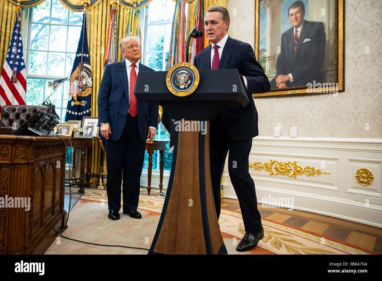 Former U.S. Senator David Perdue speaks alongside U.S. President Donald ...