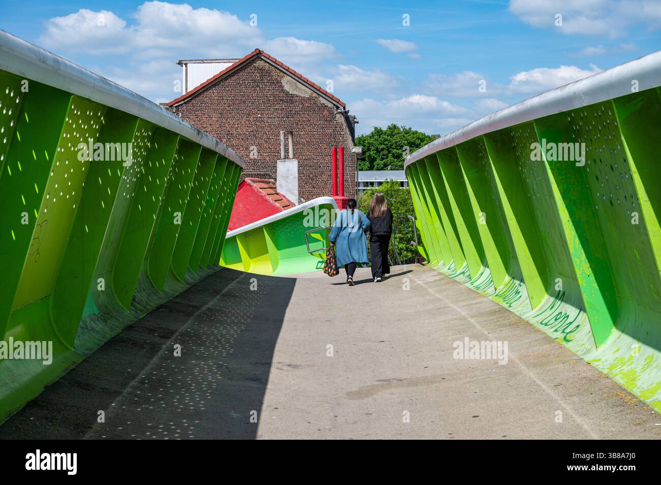 Green pedestrian bridge over railway in a social borrow of Laeken ...