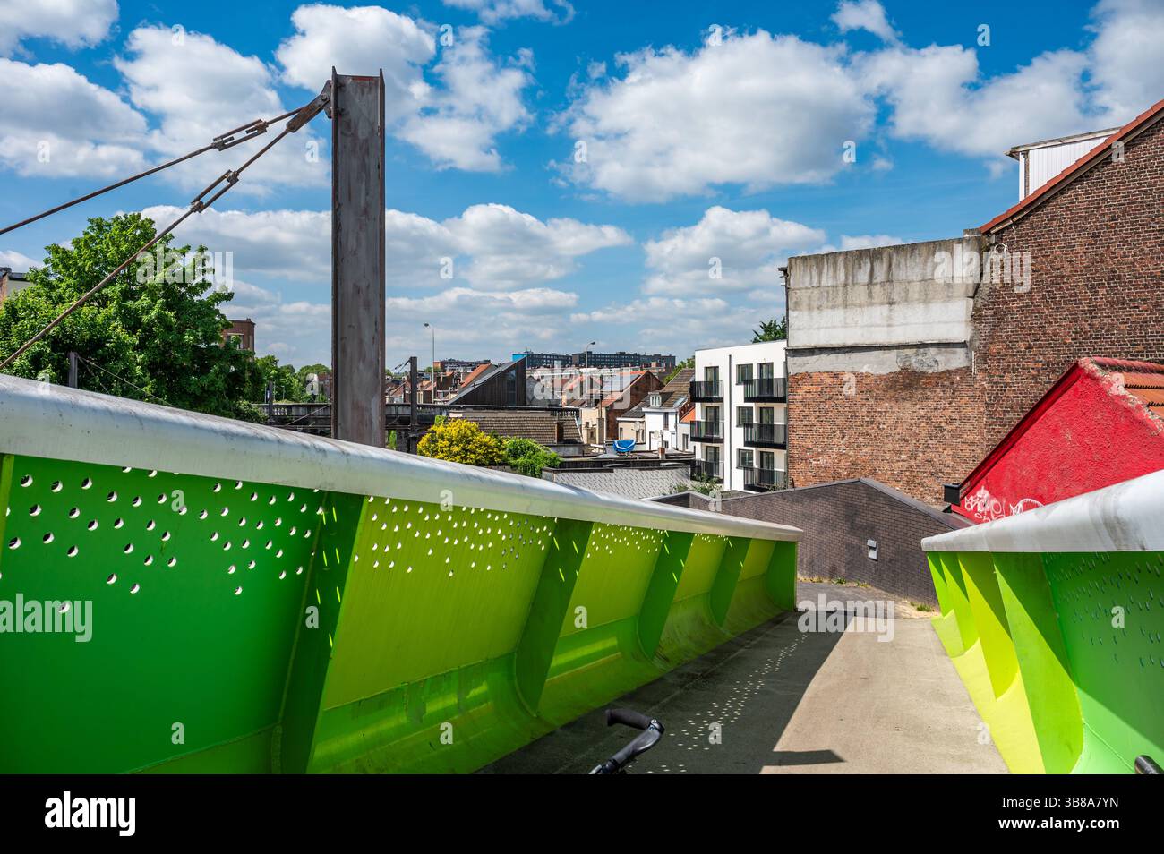 Green pedestrian bridge over railway in a social borrow of Laeken ...