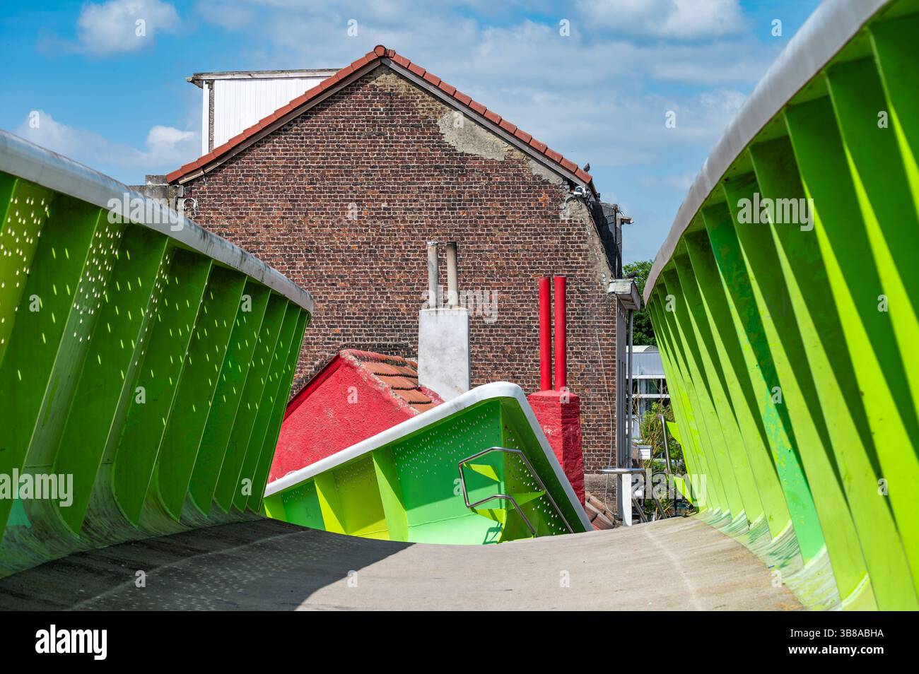 Green pedestrian bridge over railway in a social borrow of Laeken ...