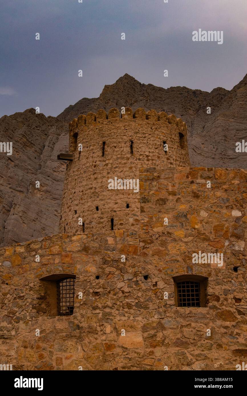 Oman: the Al Qala Fort against the mountain in Bukha, a fishing village ...