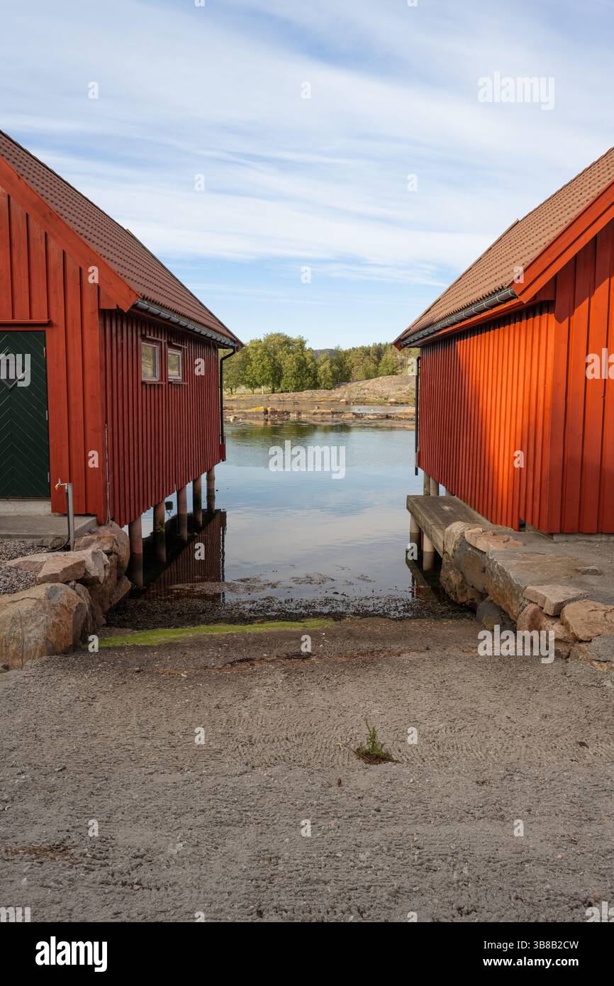 traditional red wooden boathouses by calm waters Stock Photo - Alamy